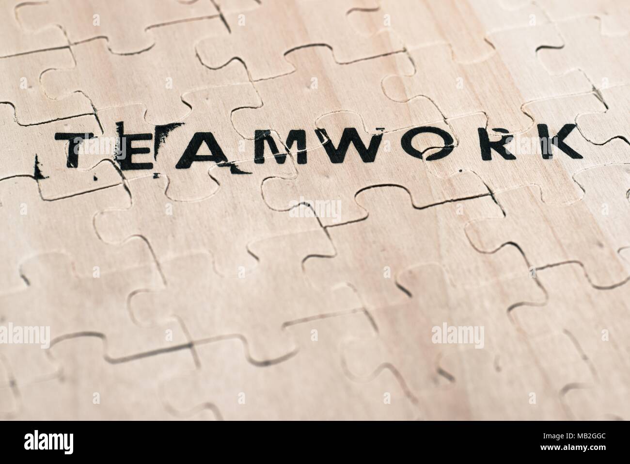 Teamwork word stamped on a wooden puzzle Stock Photo - Alamy