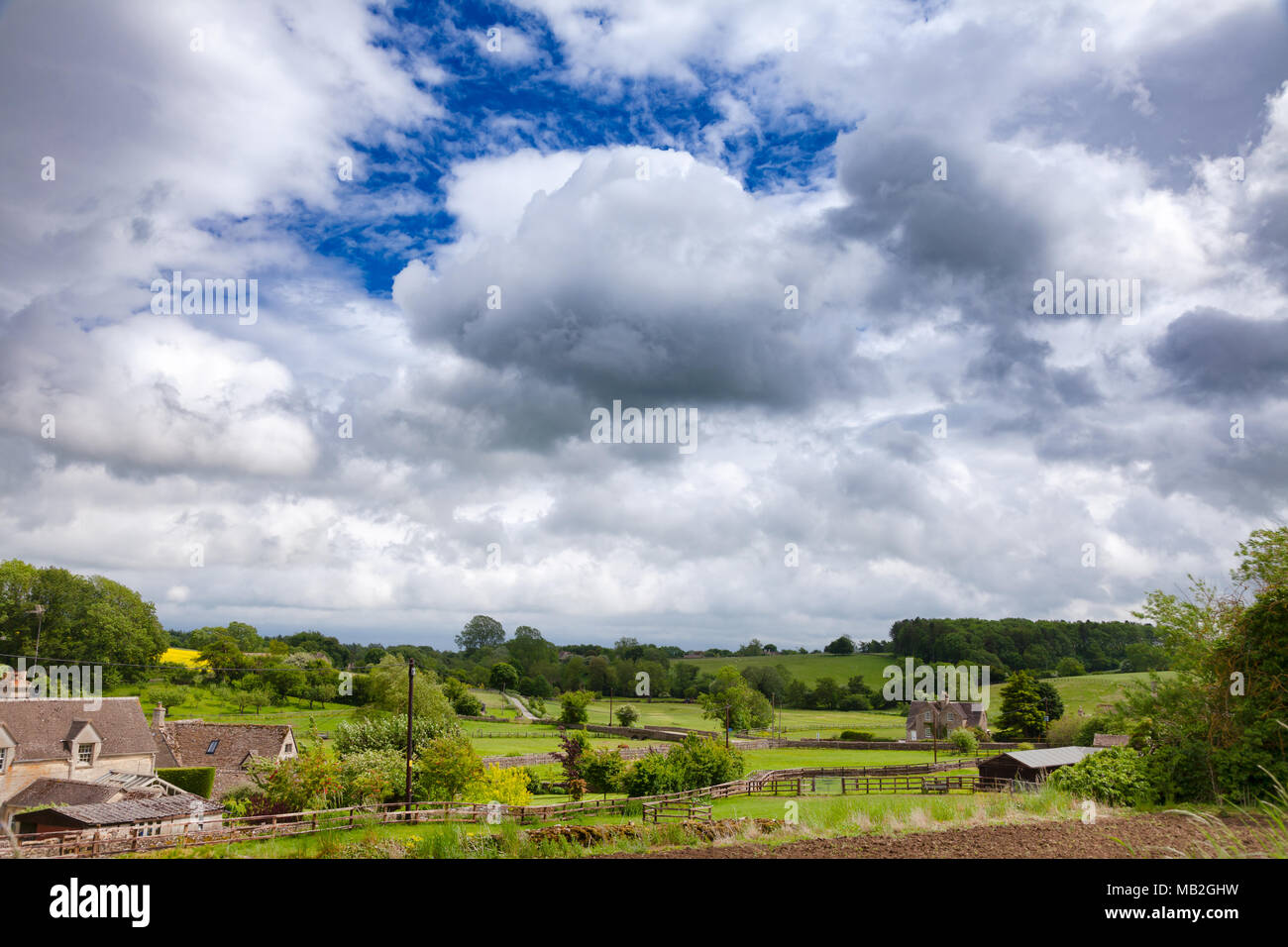 Summer english rural landscape with dramatic stormy sky over small ...