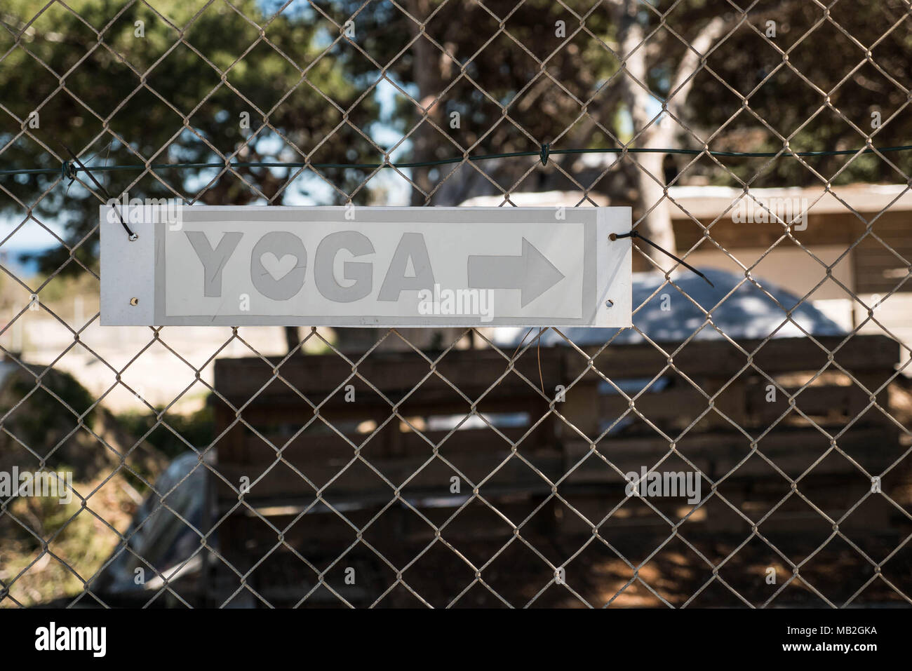 Yoga sign on a fence Stock Photo - Alamy