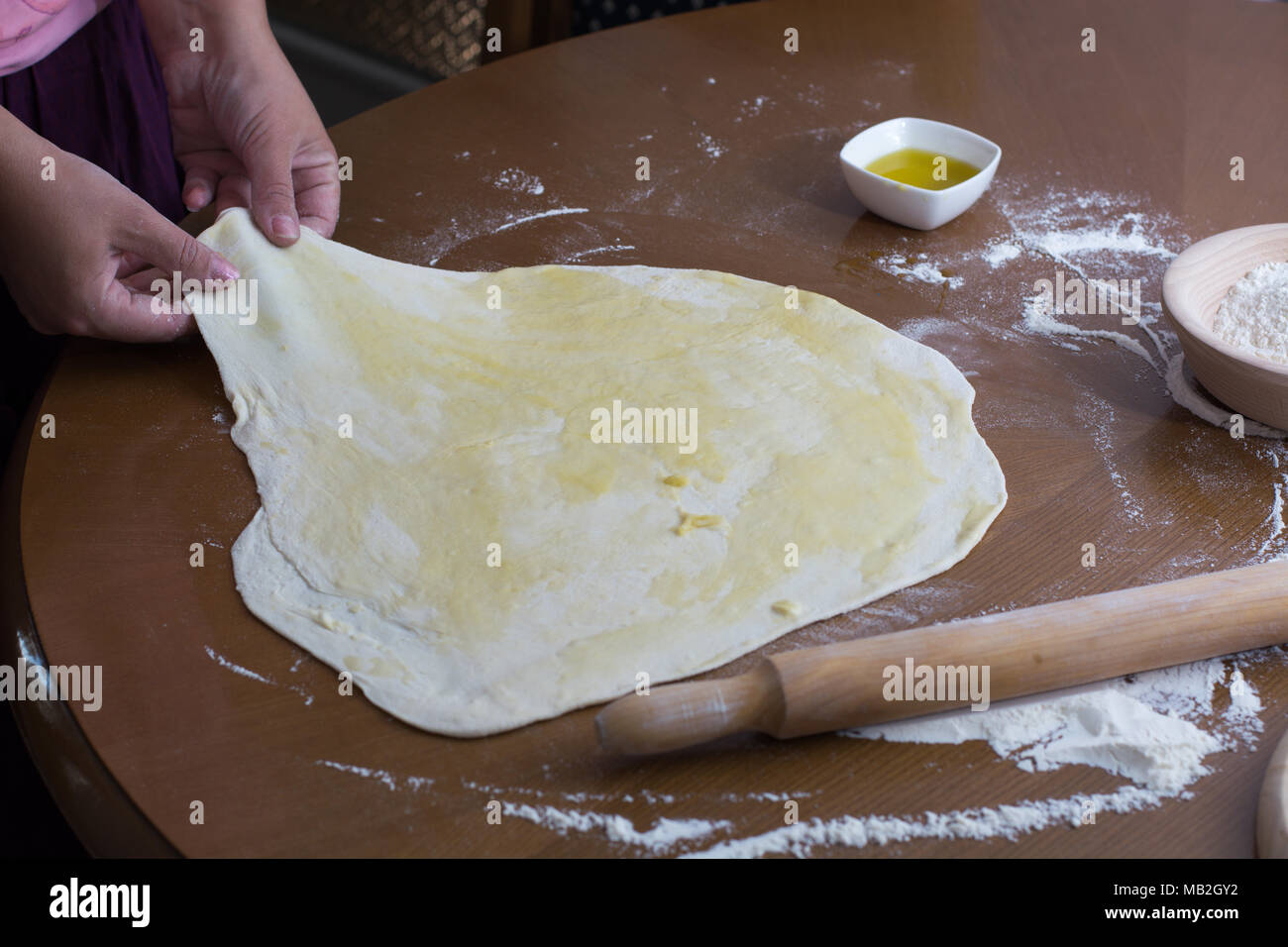 Woman making dough with meat at home on the kitchen table Stock Photo ...