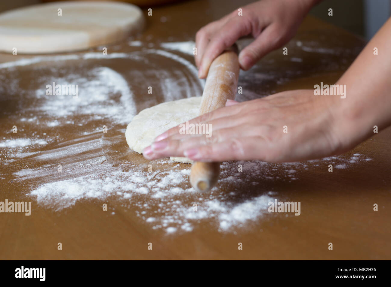 Woman making dough with meat at home on the kitchen table Stock Photo ...