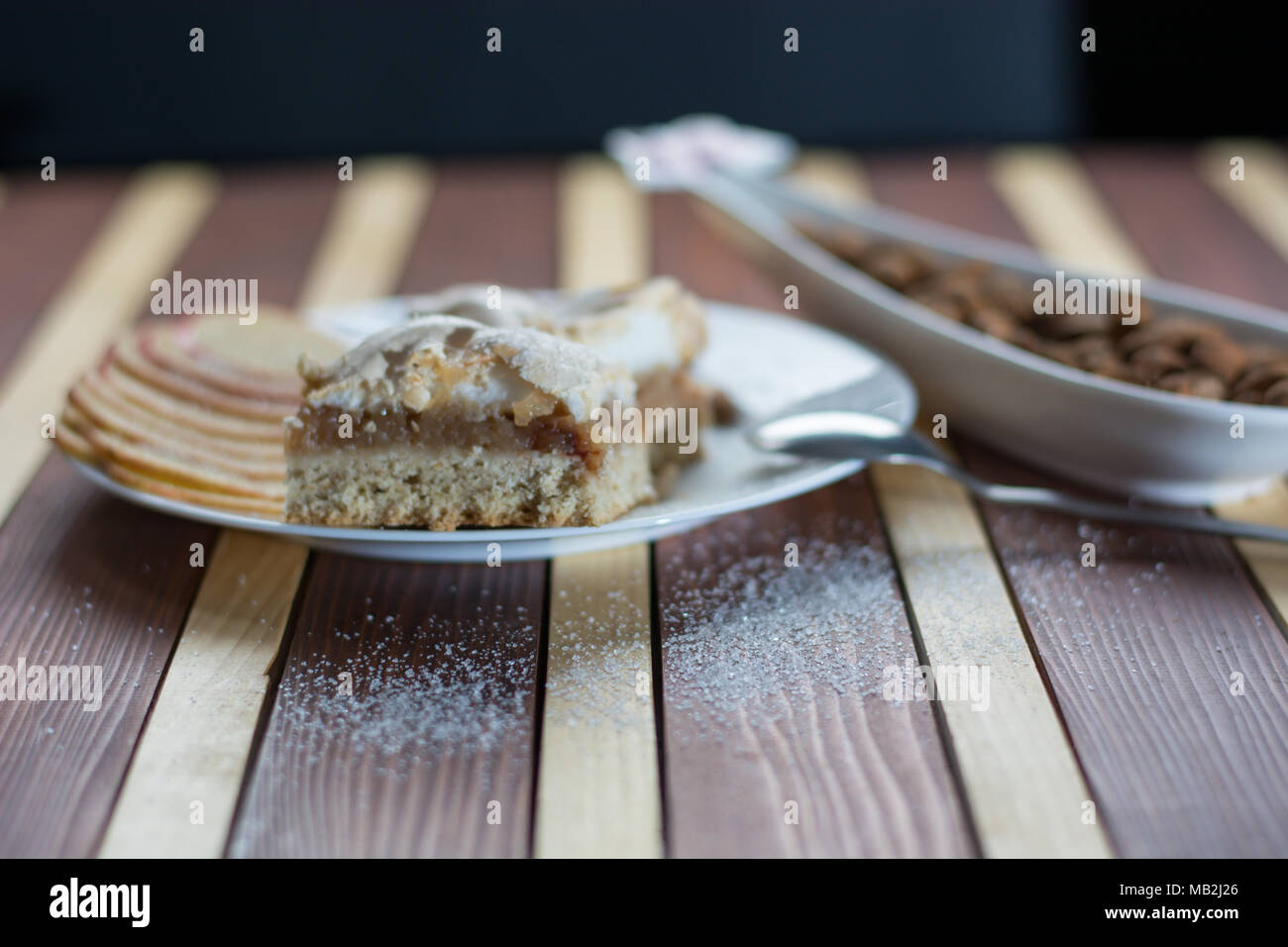 Square shape sliced omemade apple pie with kumquats and almonds on ...