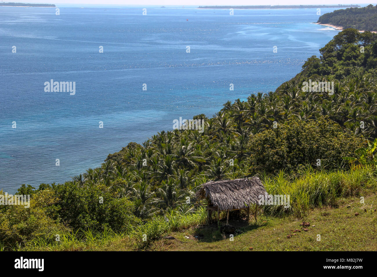 A traditional Indonesian hut on a hill with the view of Lombok Strait ...