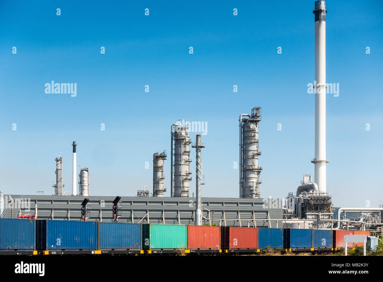 An oil refinery plant with containers ship yard Stock Photo - Alamy
