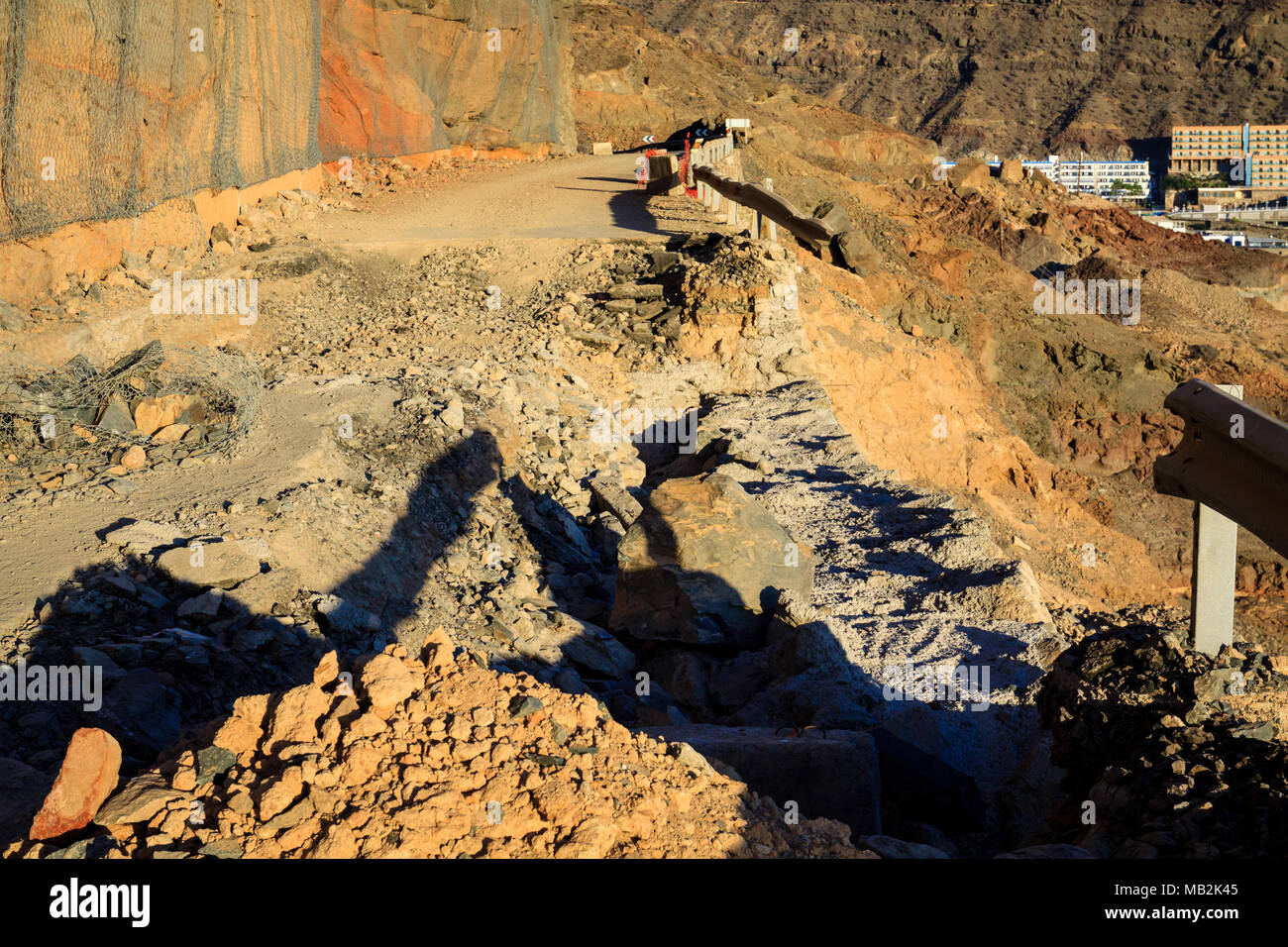 Falling rocks and big collapse hole on closed mountain road Stock Photo ...