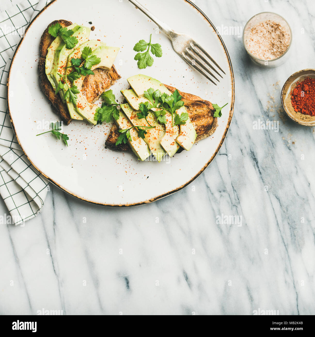 Avocado toast with seasoning and lemon water, square crop Stock Photo ...