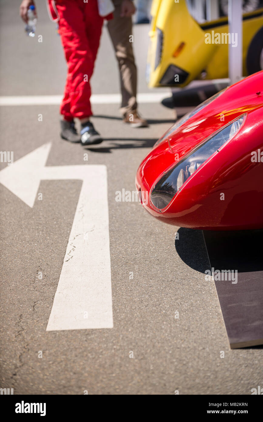 classic cars waiting at the pit for their great race with drivers ...