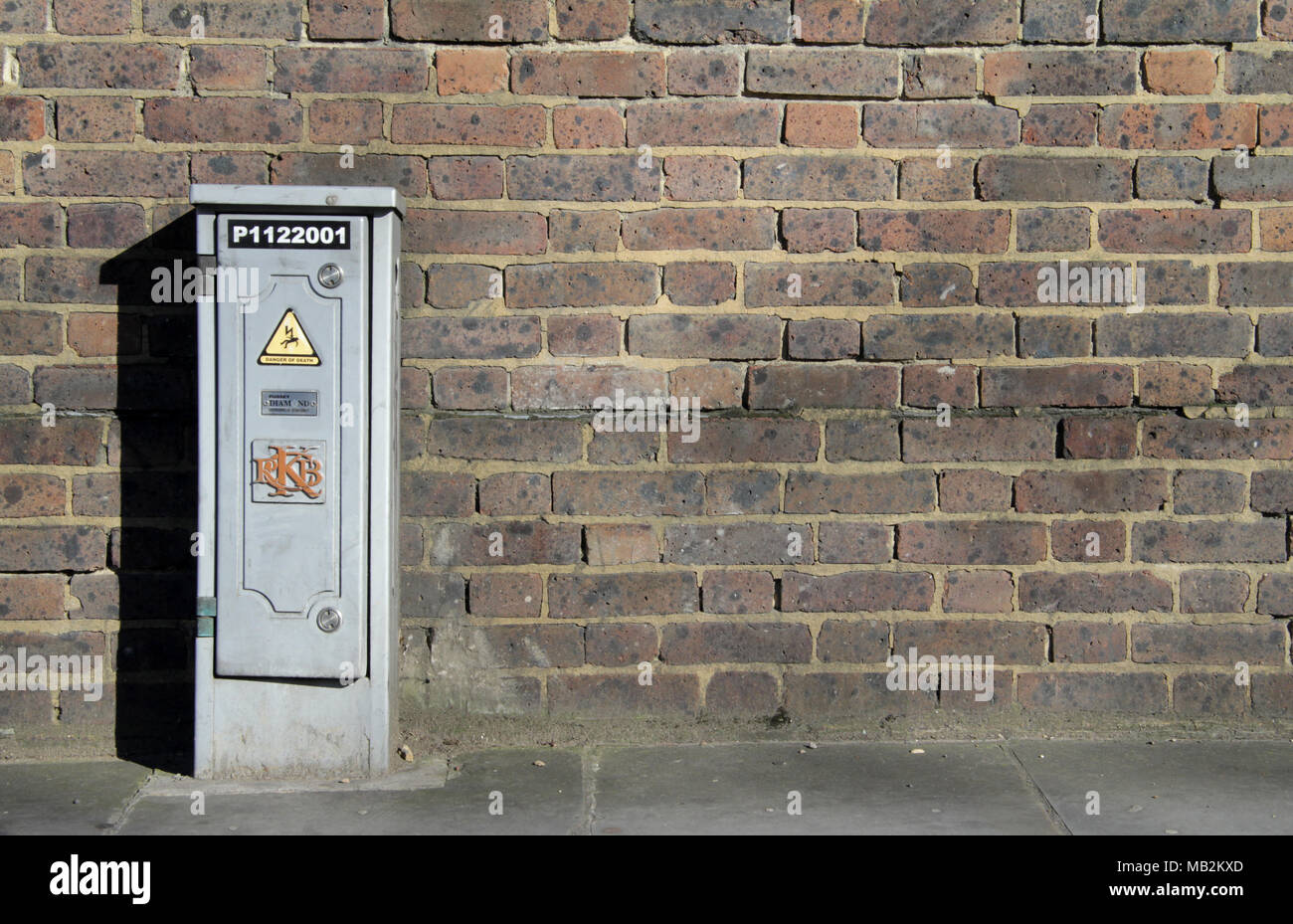 Streetside Electrical Boxes against brickwork wall Stock Photo - Alamy