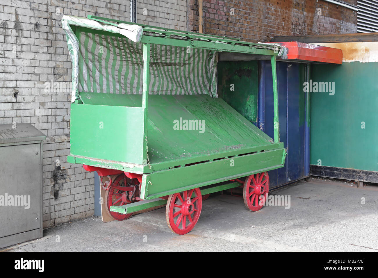 Empty Green Vendor Cart With Red Wheels Stock Photo - Alamy