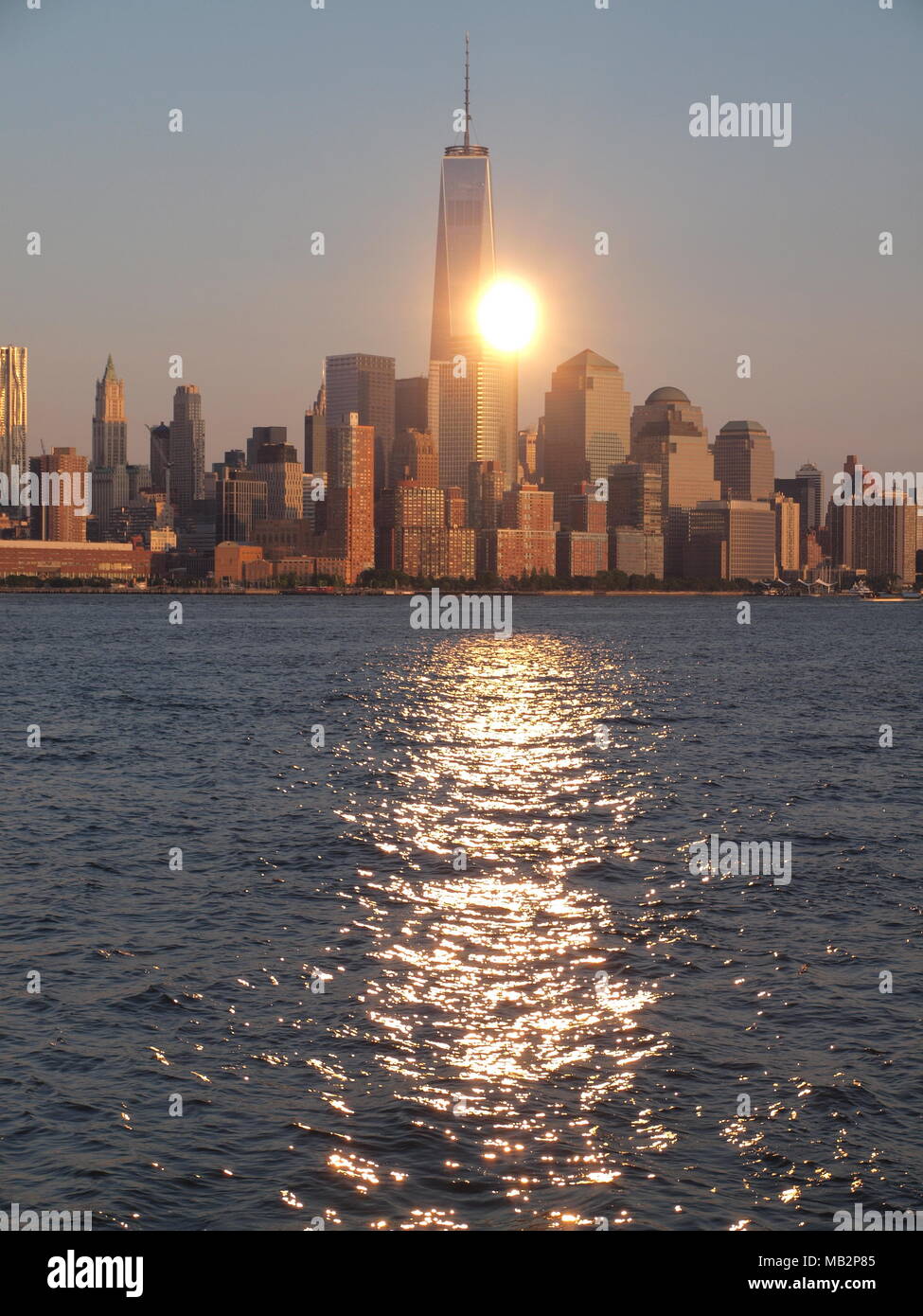 Lower Manhattan NY, Skyline with Freedom Tower and reflection of sun ...