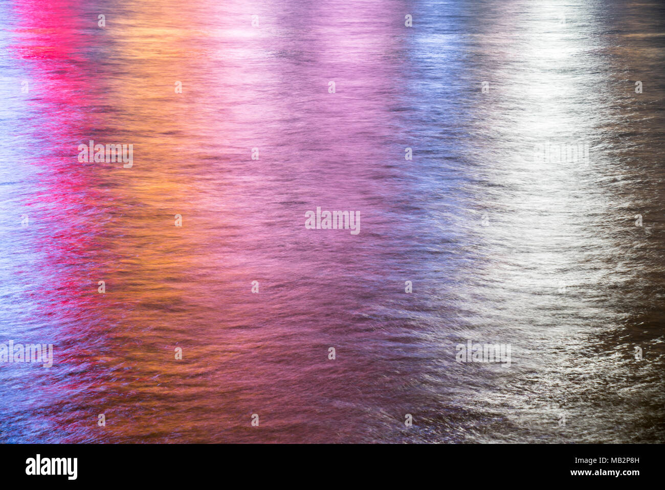 Abstract reflected glory, colors of city lights on low rolling water ...