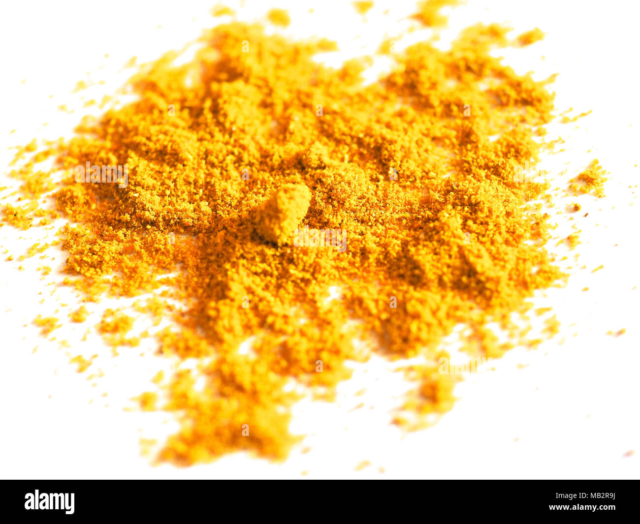 Curry powder is a blend of hot Indian spices over white background ...