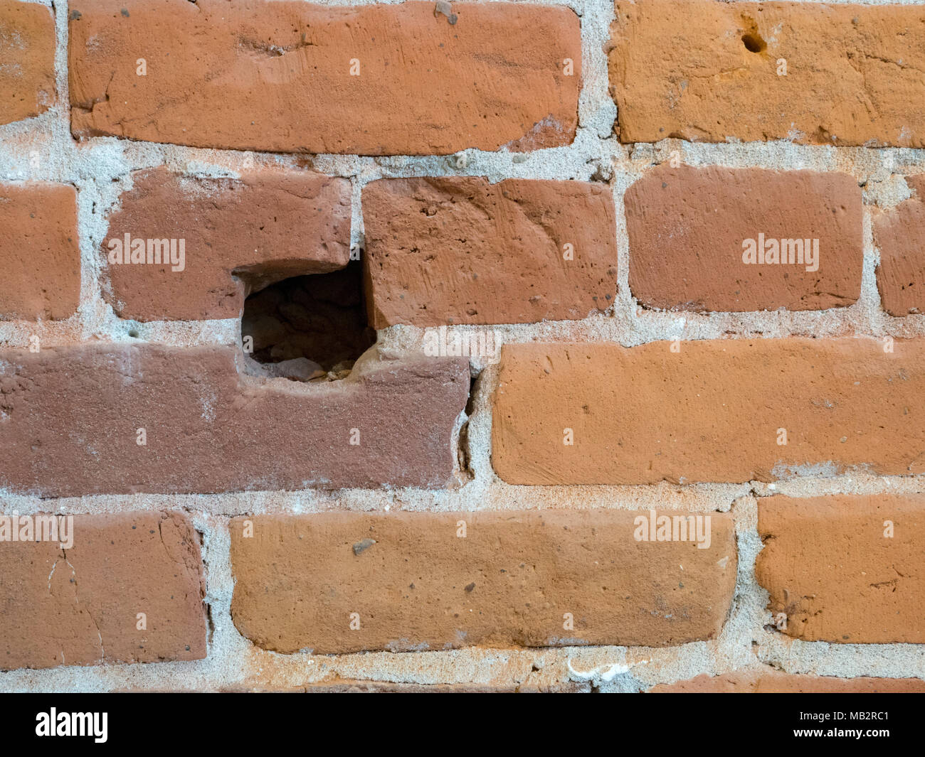 Hole in a brick wall with space to the right of it Stock Photo - Alamy