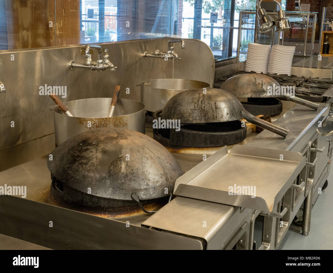 Three woks ready to cook in industrial kitchen afterhours Stock Photo ...