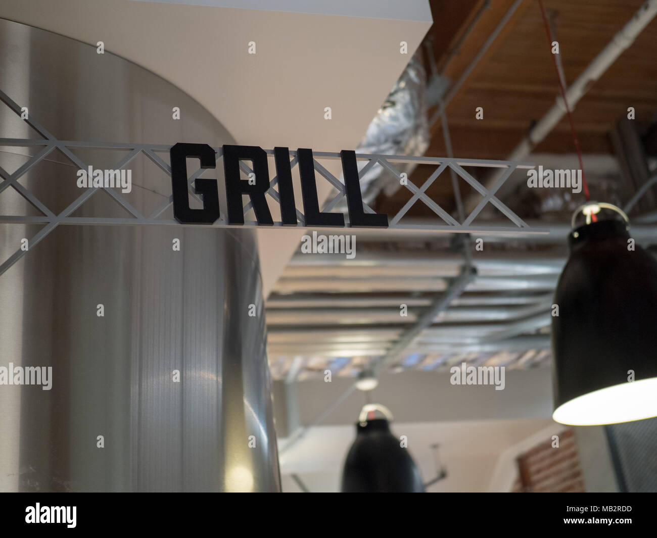 Modern steel grill sign hanging in dining area Stock Photo - Alamy