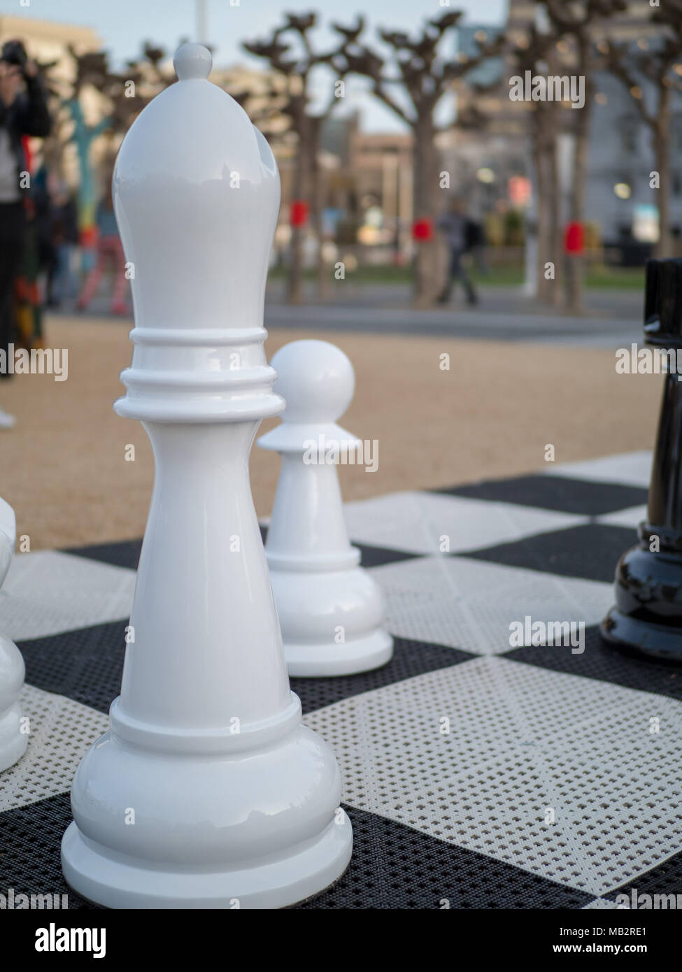 Giant, life-sized bishop piece on a chess board in a park Stock Photo ...