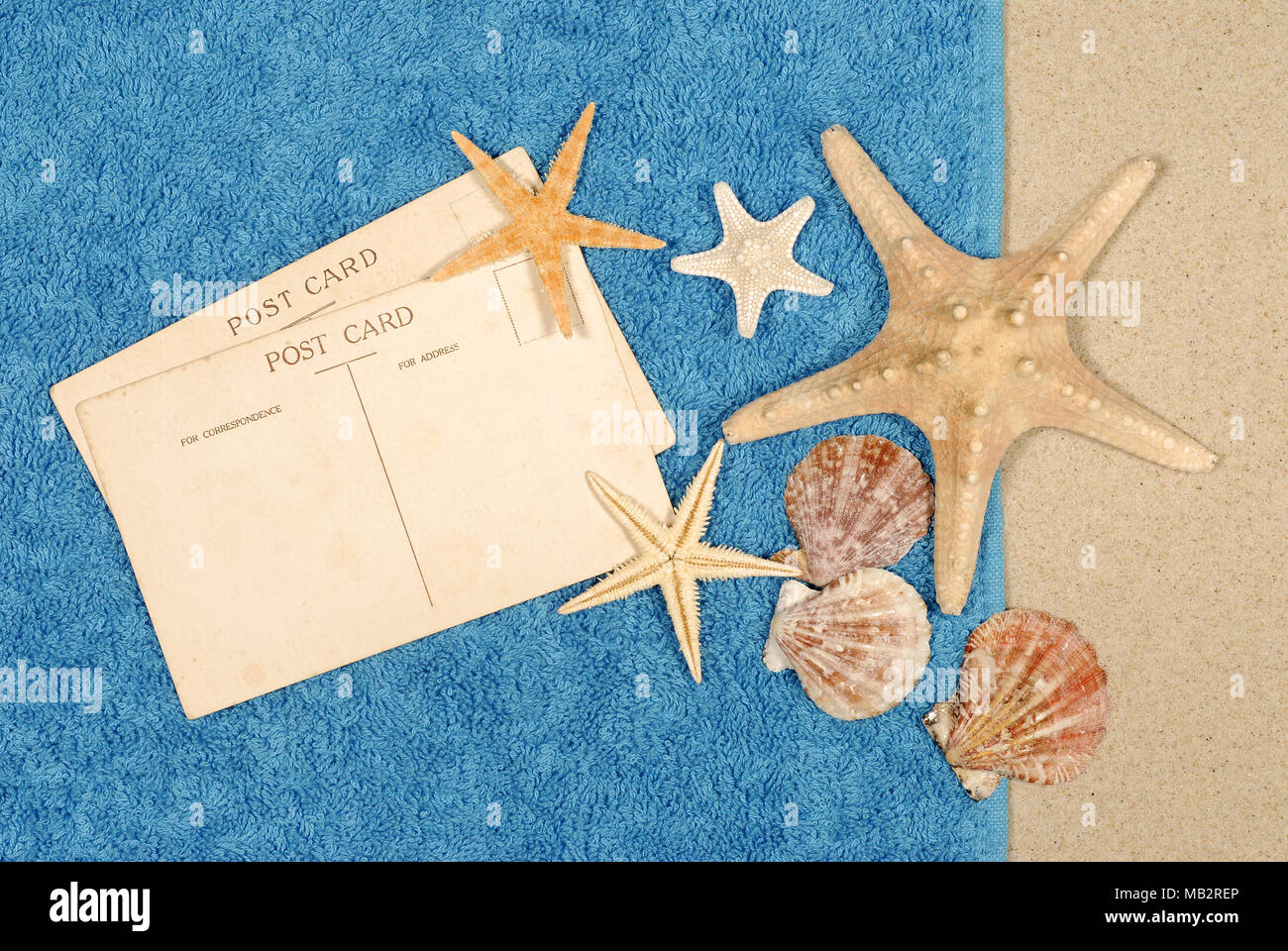 Seashore background with postcards shells beach towel and starfish ...