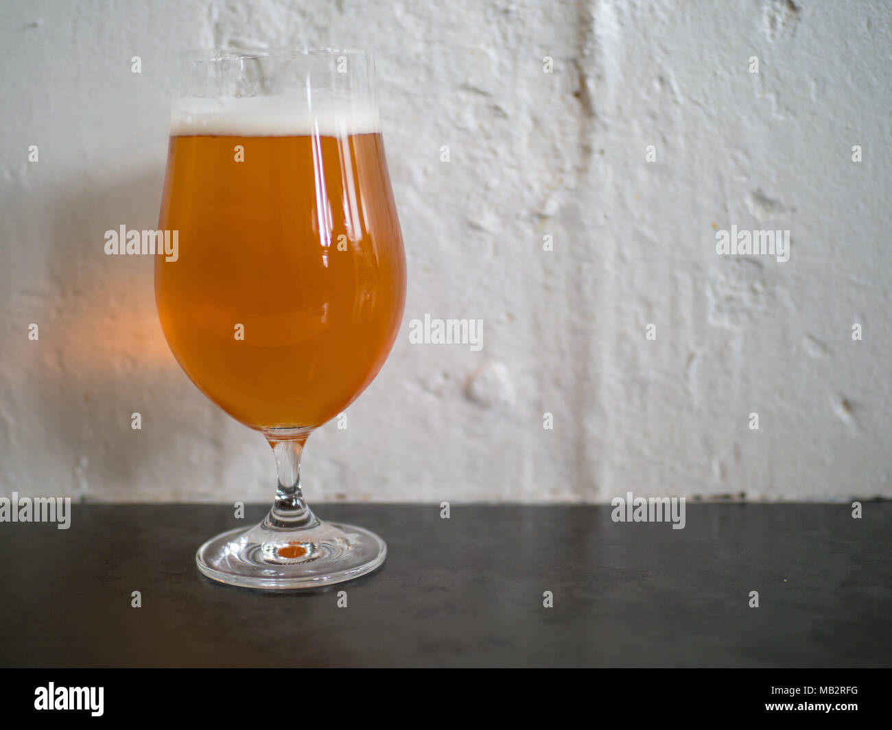 Closeup of an IPA beer in a glass on a bar counter top Stock Photo - Alamy