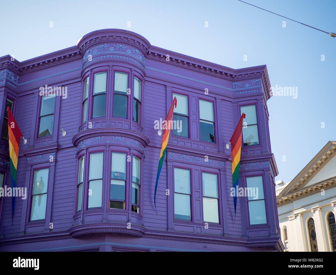 Purple house with LGBT pride rainbow flags hanging on a sunny day Stock ...