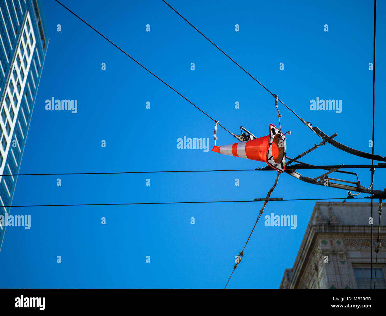 Hanging safety cone on electric bus lines on a street outdoors Stock ...