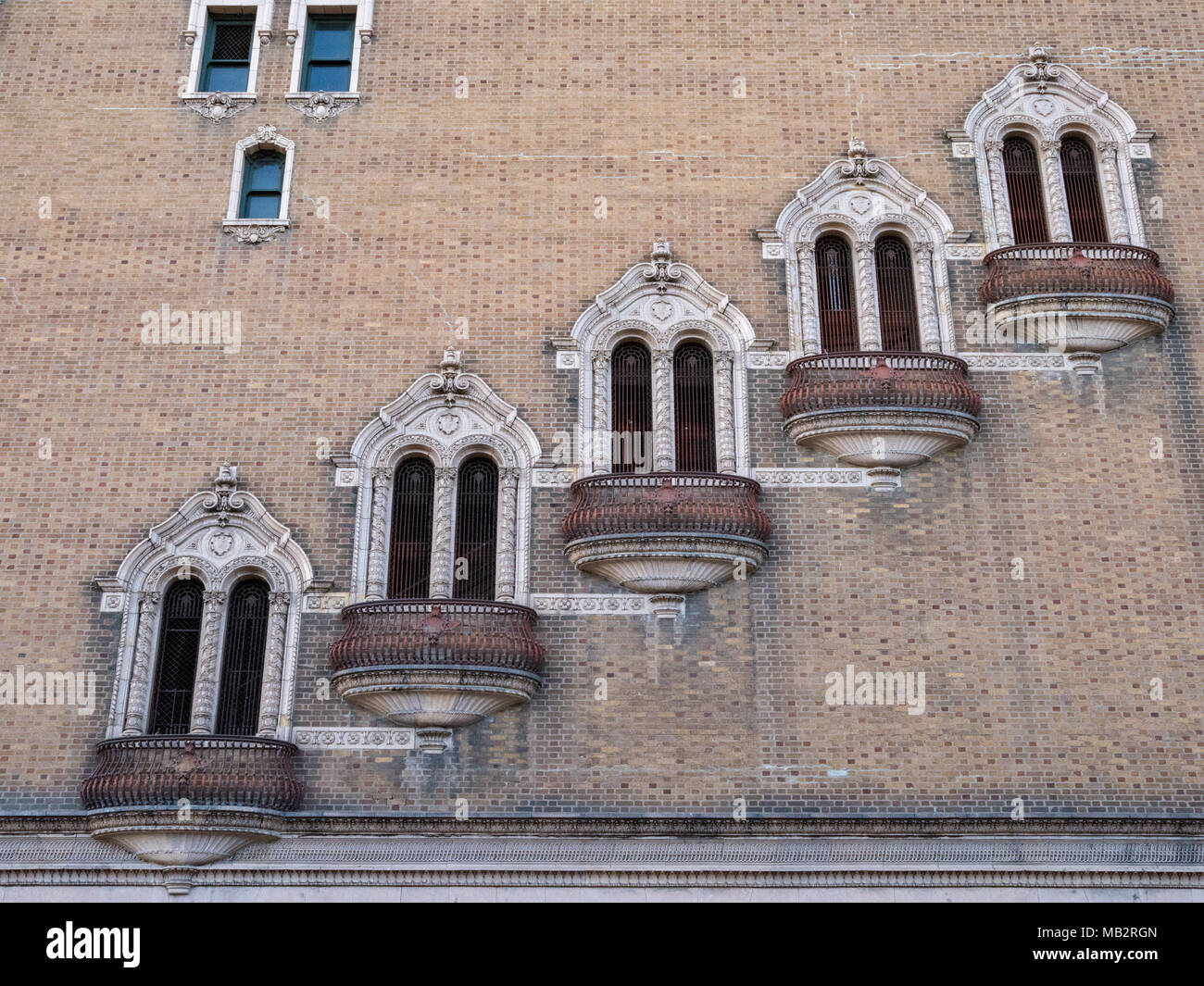 Row of staggered, rusty, outdoor balconies on the side of a building ...