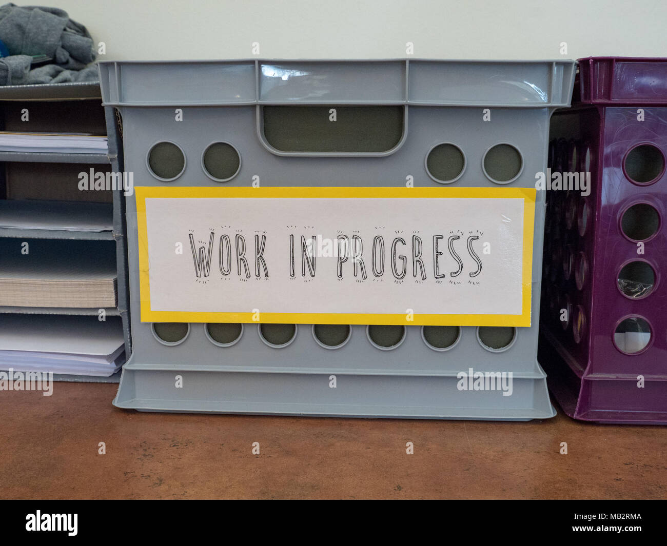 "Work in progress" handwritten sign on storage bin Stock Photo - Alamy