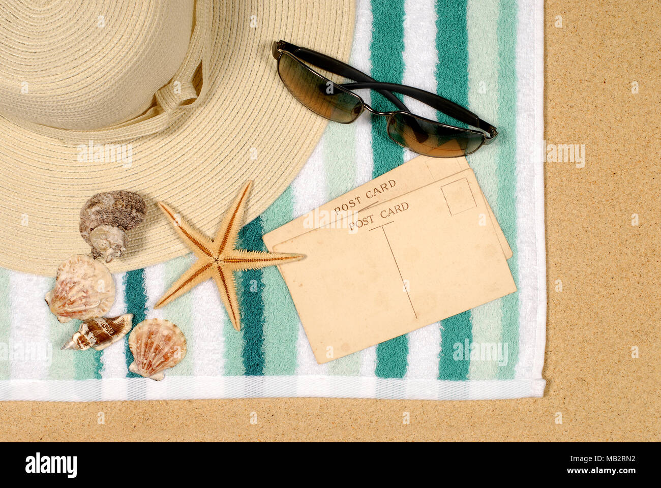 Seashore background with postcards shells beach towel and starfish ...