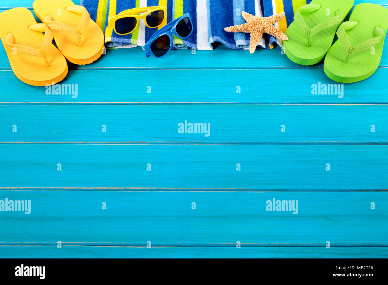 Beach border scene with striped towel, flip flops, sunglasses and ...