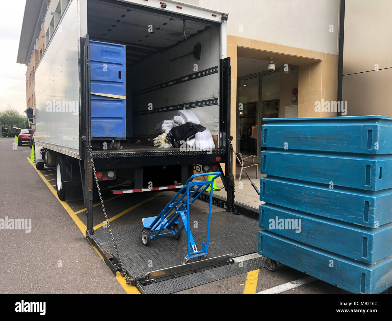 Bulk laundry delivery service, large carts on ramp of truck for ...