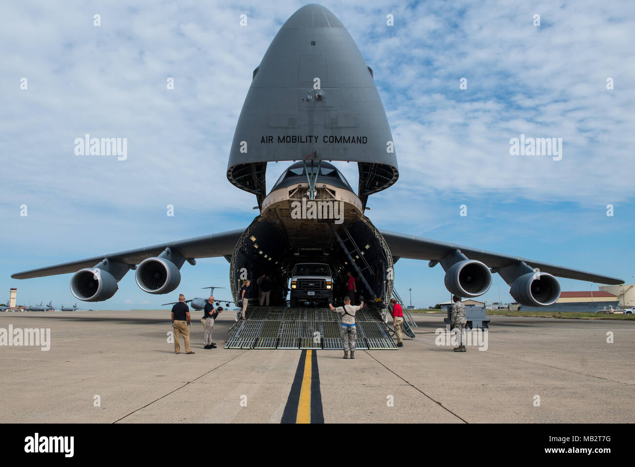 Senior Airman Jacob New, 60th Aerial Port Squadron, demonstrates to ...