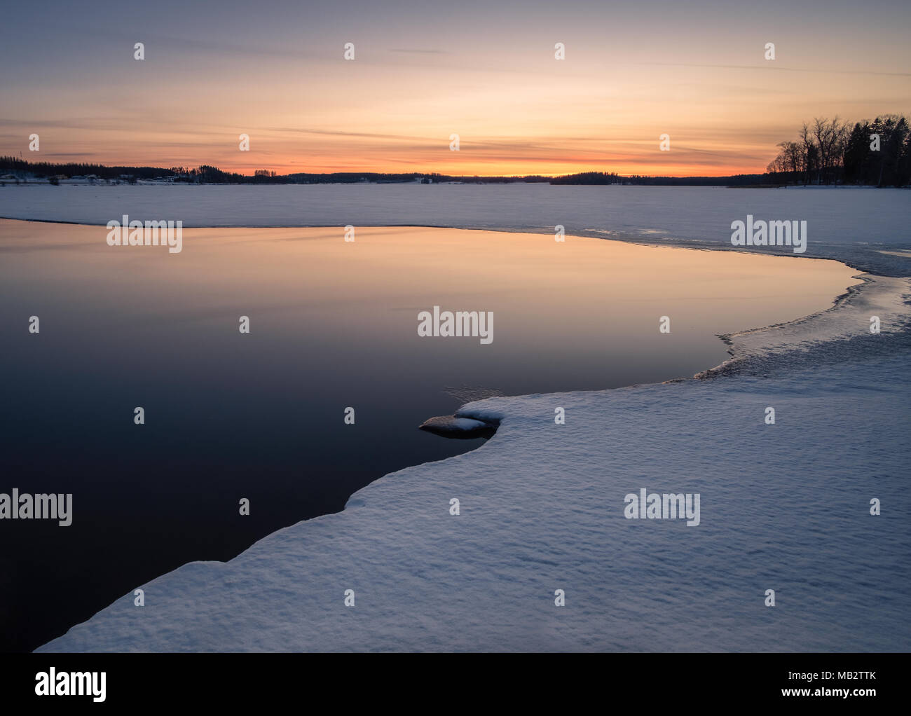 Scenic landscape with melted lake an sunset at evening in Finland Stock ...
