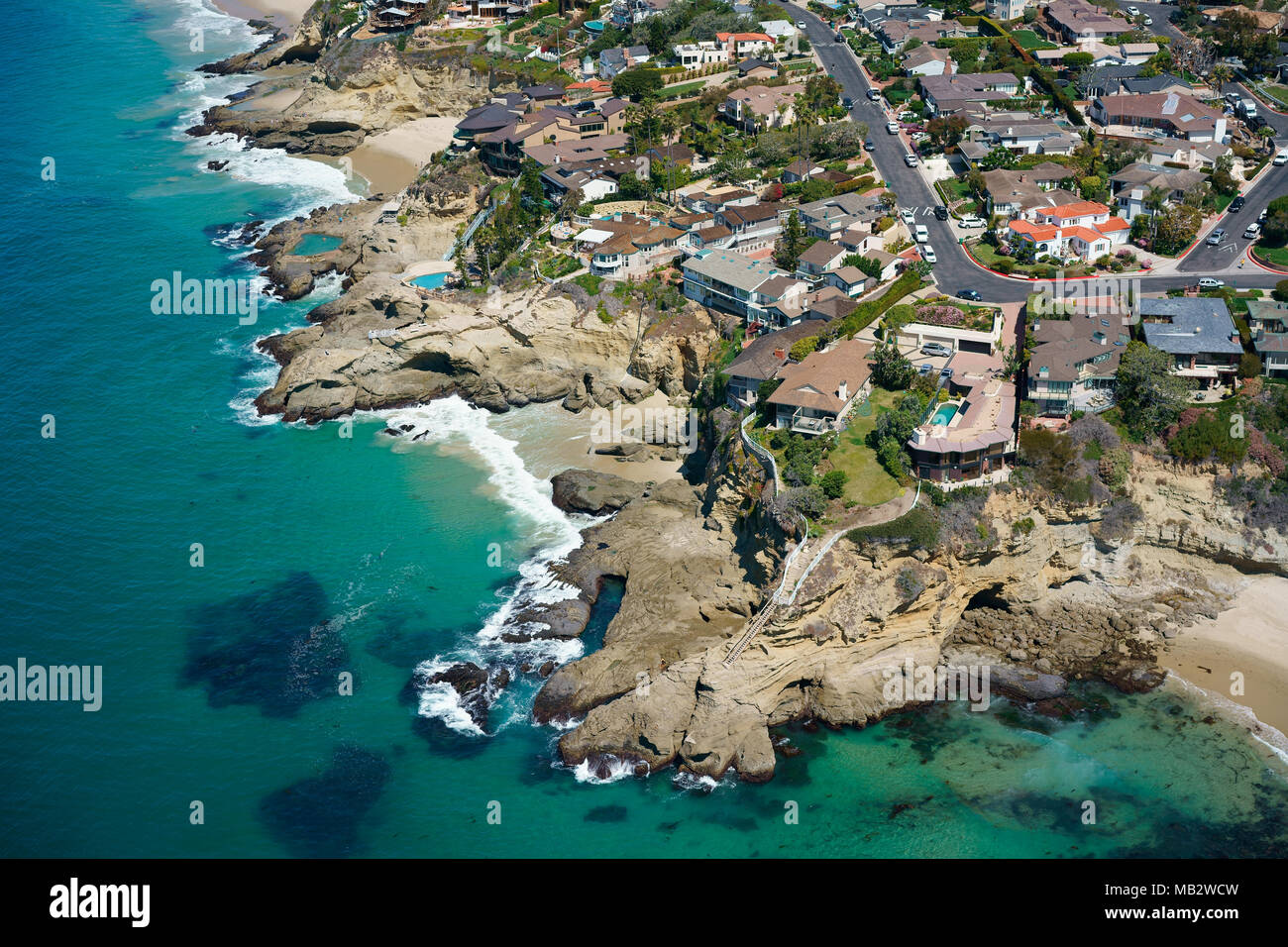 AERIAL VIEW. Dream houses on a jagged coastline overlooking the Pacific ...