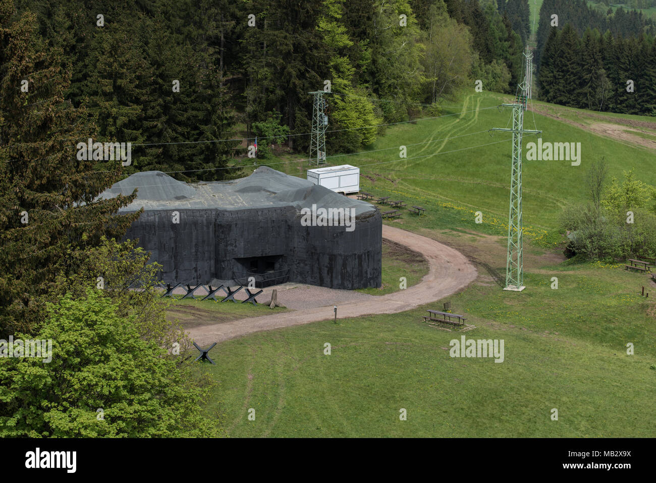 A World War Two concrete Old german bunker with the electric poles and ...