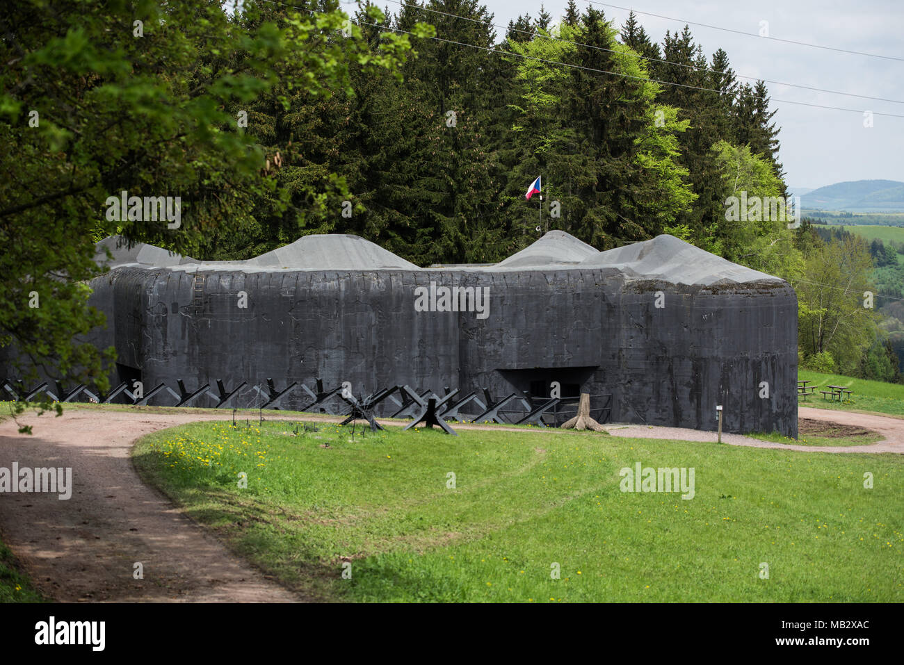 A World War Two concrete Old german bunker with the electric poles and ...