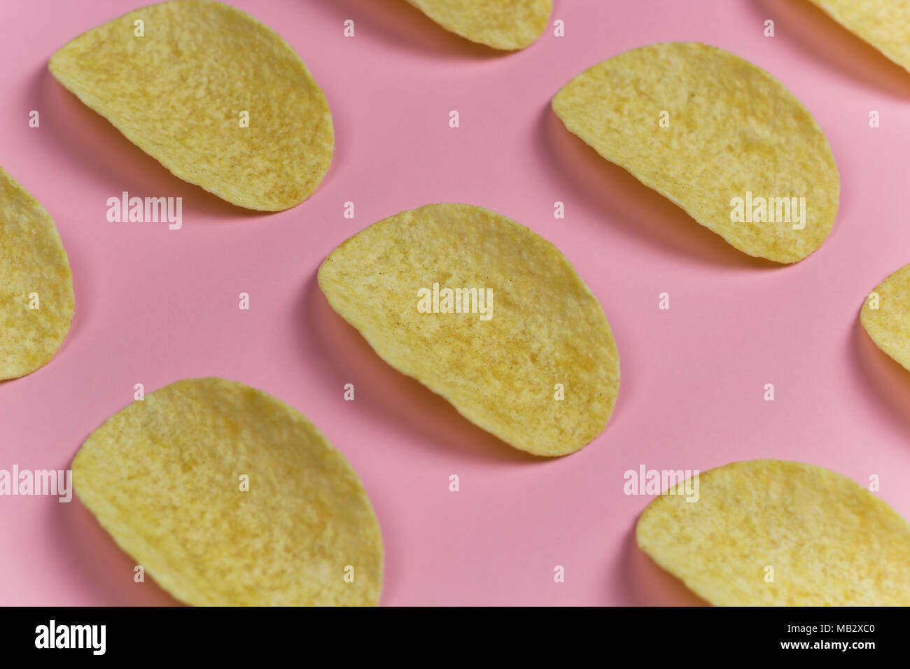 top view chips pattern pink pastel background Stock Photo - Alamy