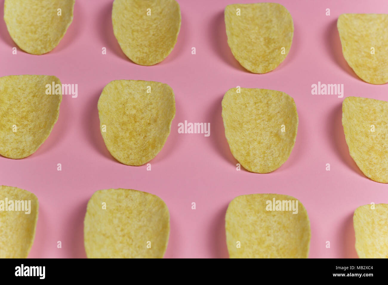 top view chips pattern pink pastel background Stock Photo - Alamy