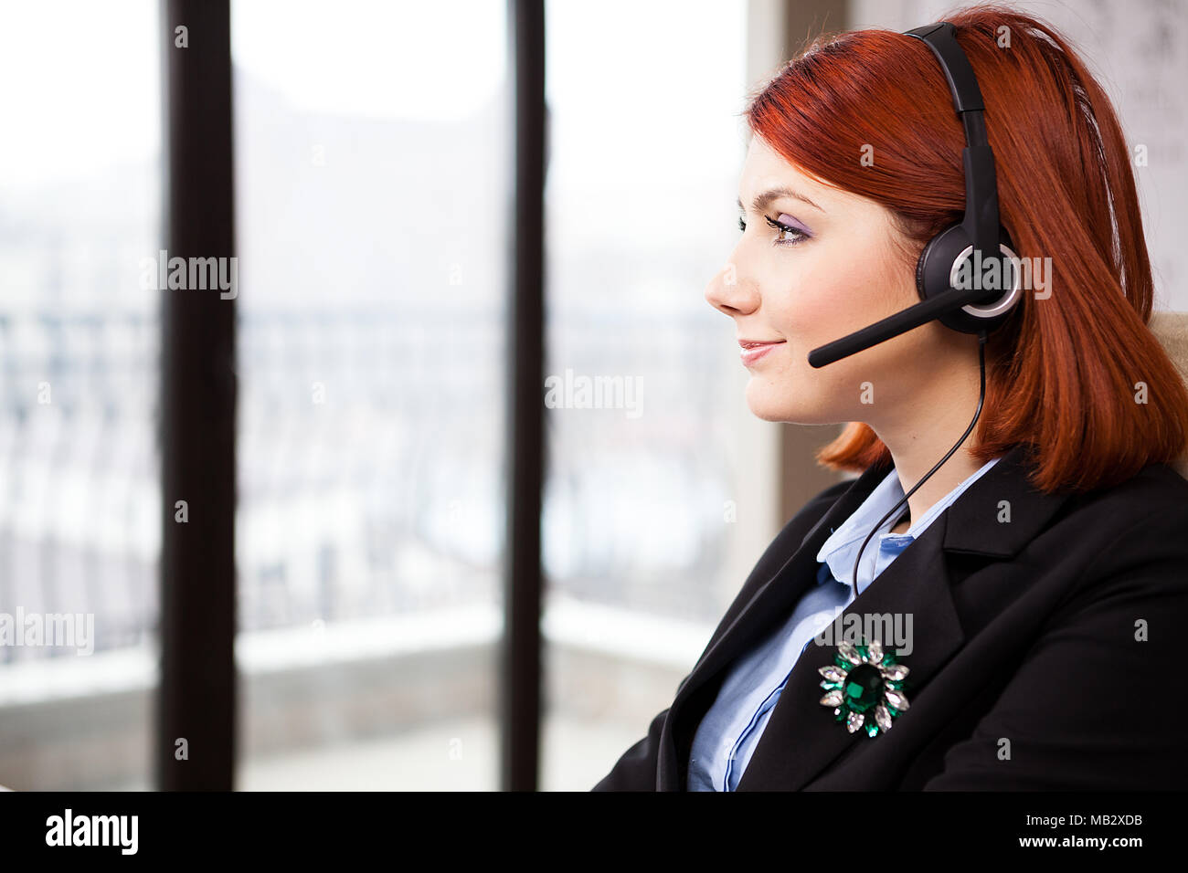 Smiling customer support line worker Stock Photo - Alamy