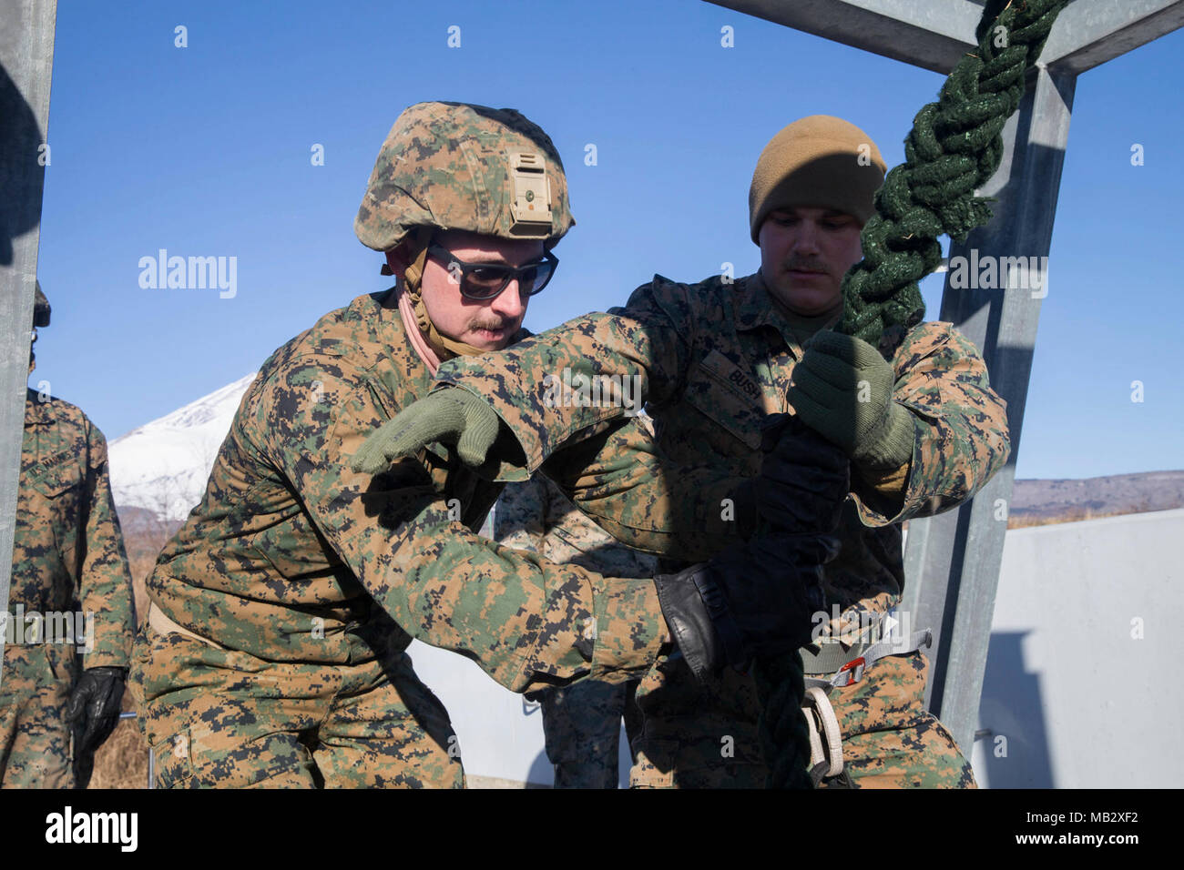 U.S. Navy Corpsman Petty Officer 3rd Class John Cunningham fast ropes ...