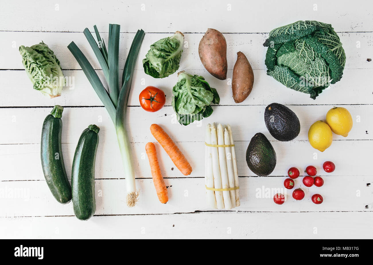 Flat lay of arranged fresh vegetables lying in order on white wood ...