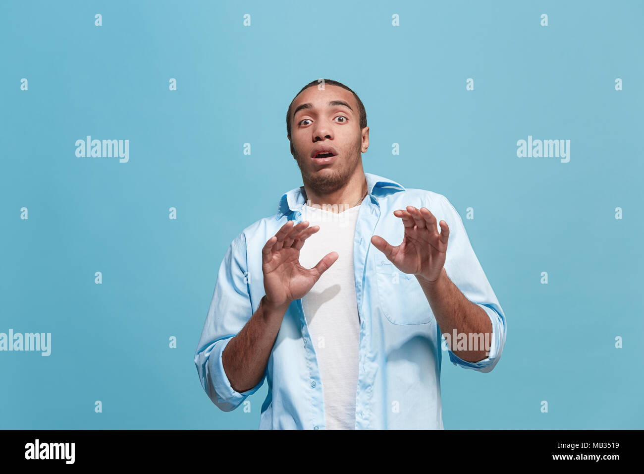 Portrait of the scared man on blue Stock Photo - Alamy