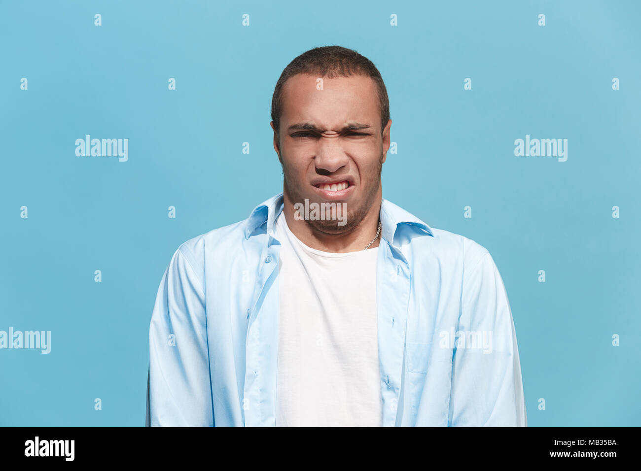 Young man with disgusted expression repulsing something, isolated on ...