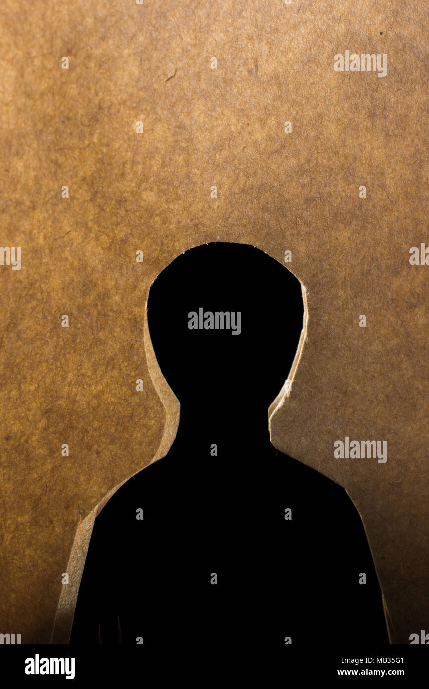 Man shape cut out of paper in hand in the view Stock Photo - Alamy