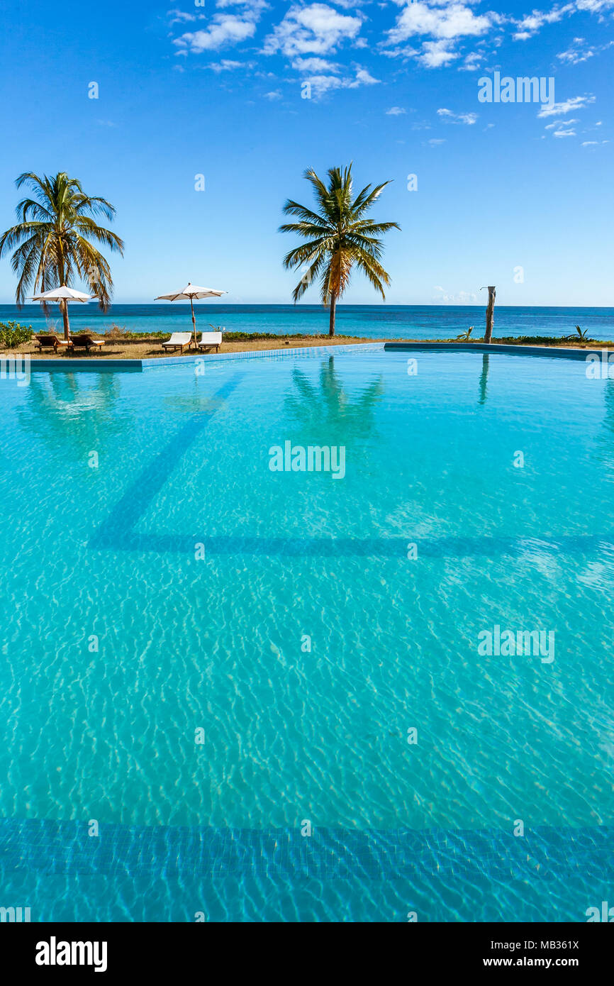 Tropical swimming pool overlooking the sea Stock Photo - Alamy