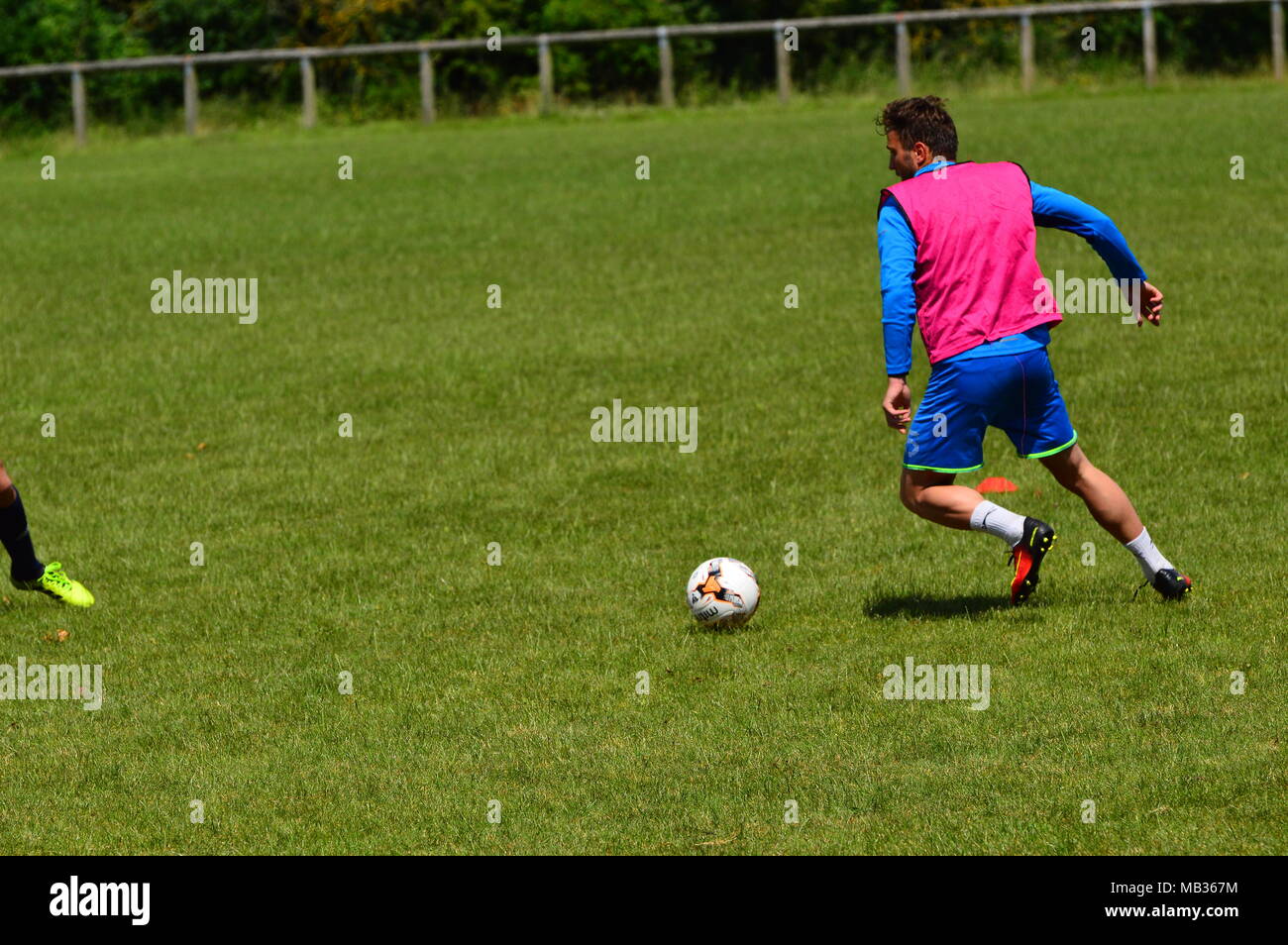 Football player dribbling Stock Photo - Alamy
