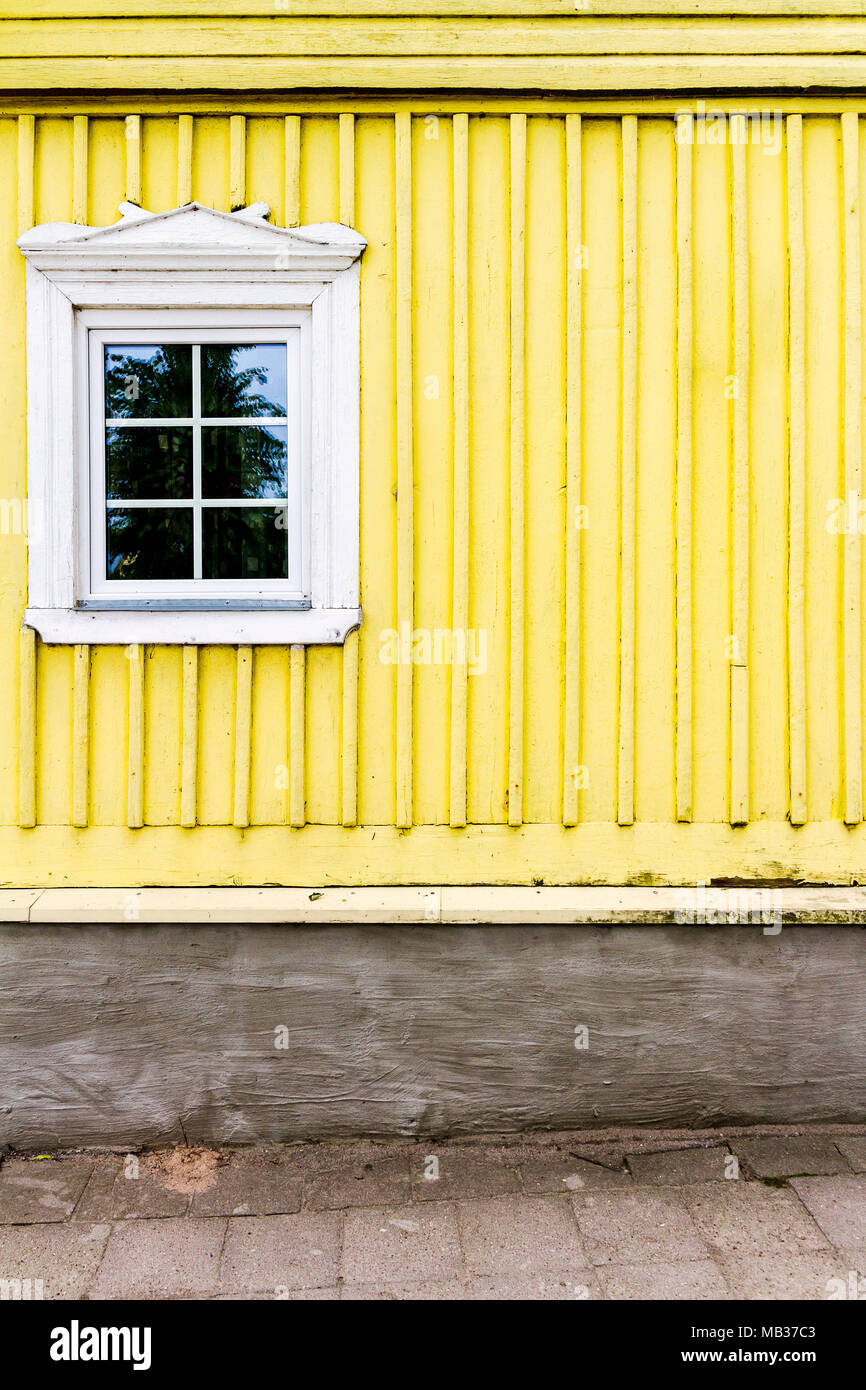Old window on a aged yellow wooden wall. Architectural detail ...