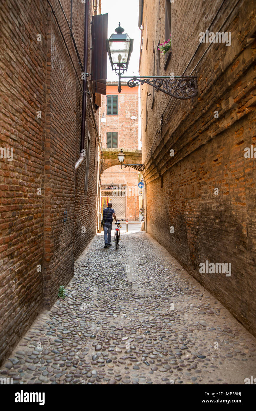 Ancient and narrow medieval street in Ferrara, Italy Stock Photo - Alamy