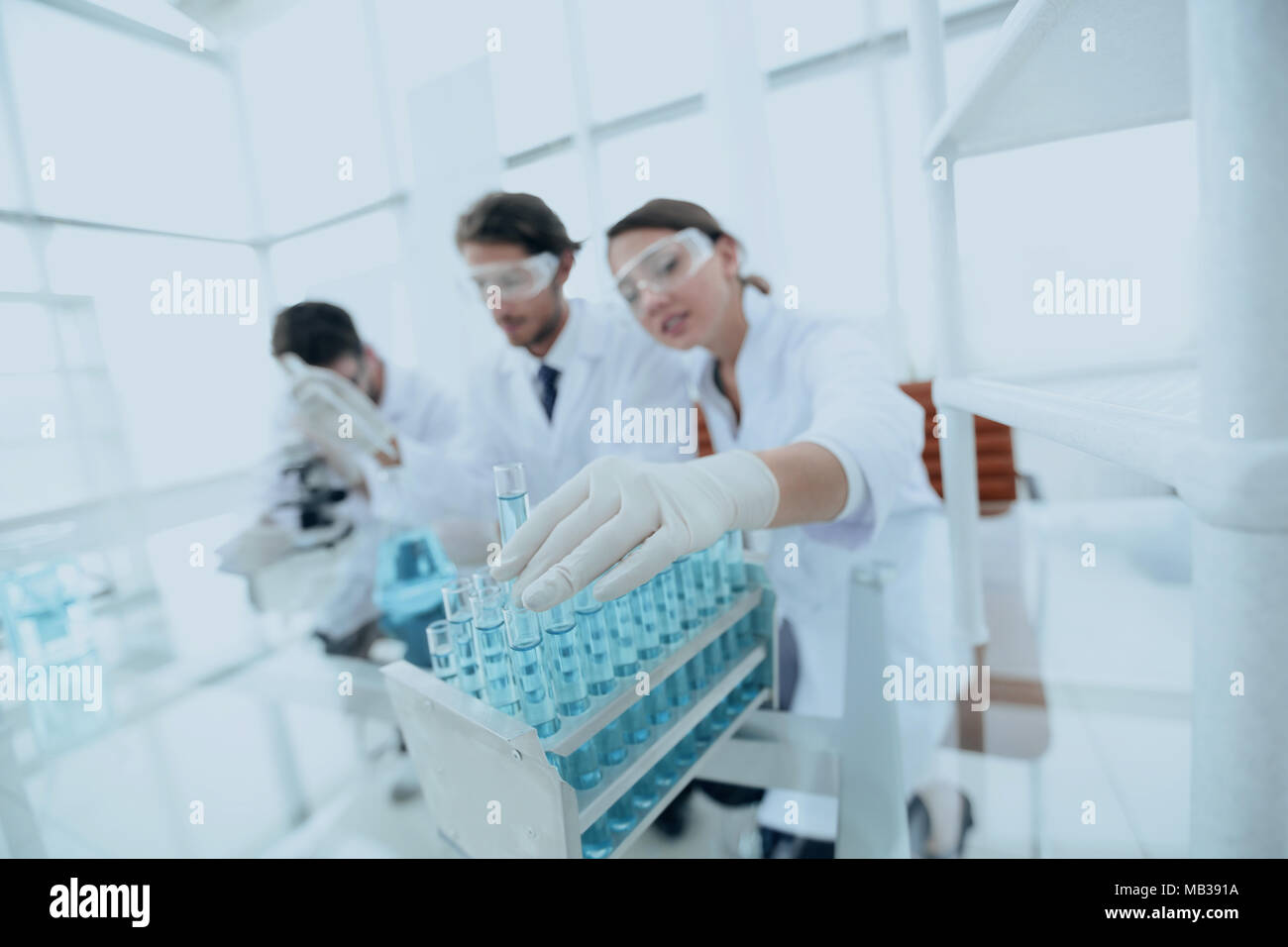 Scientist holding test tube or some equipment of science Stock Photo ...
