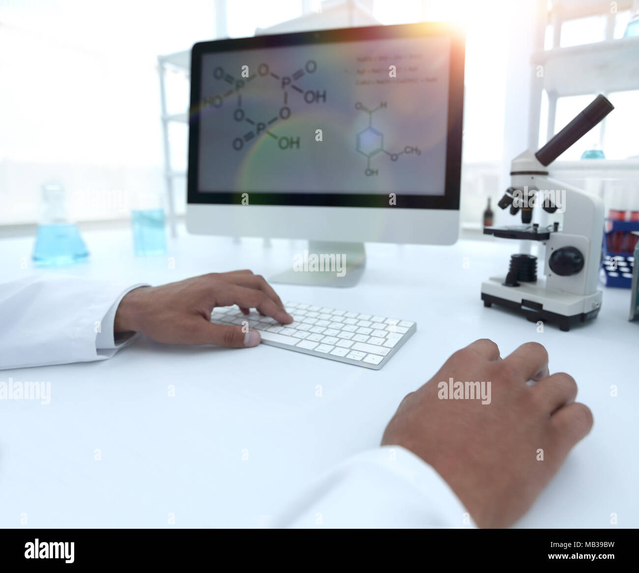 A scientist uses a computer and a microscope Stock Photo - Alamy