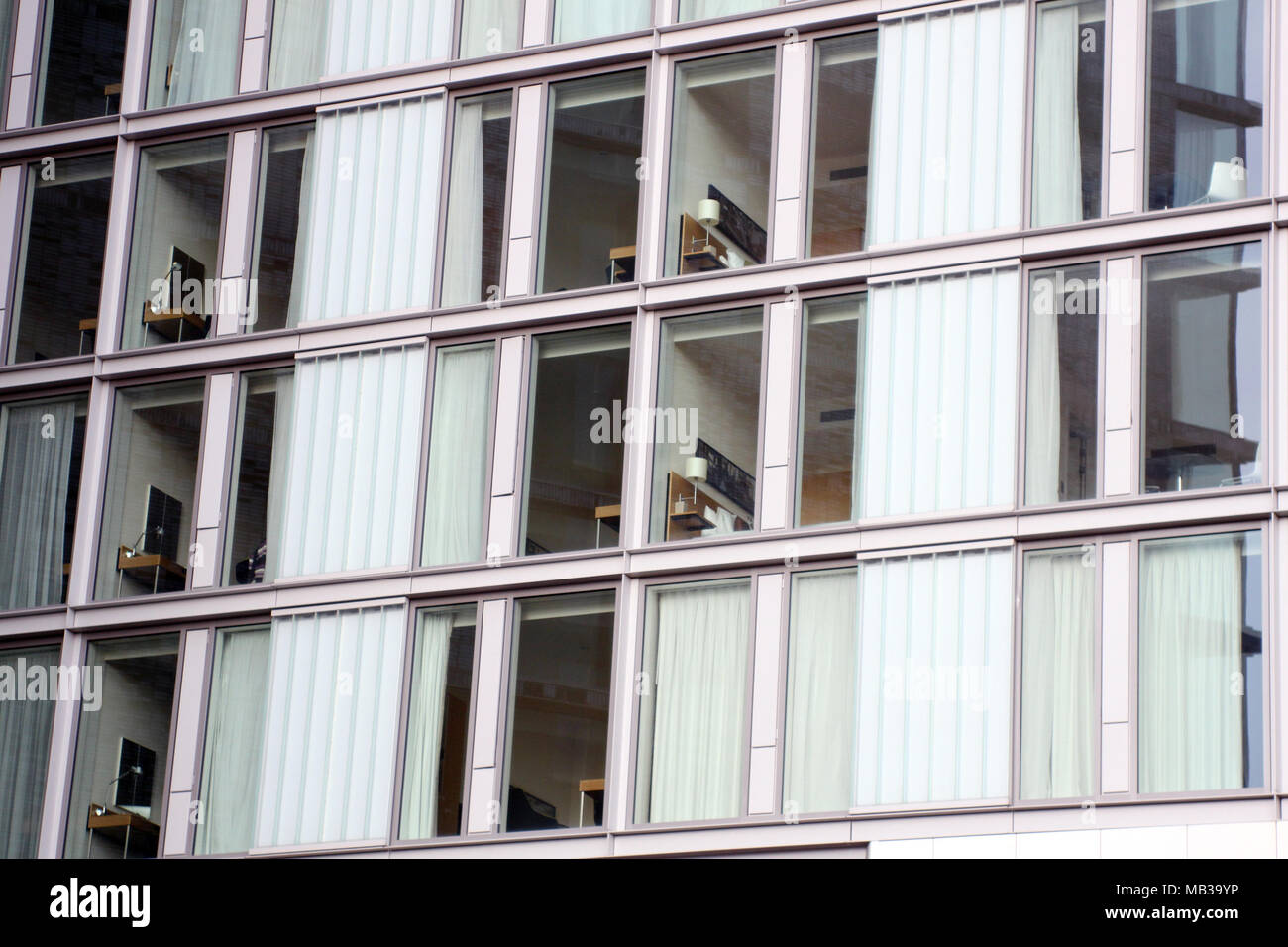 Facade of hotel and rooms, big windows and beds Stock Photo - Alamy