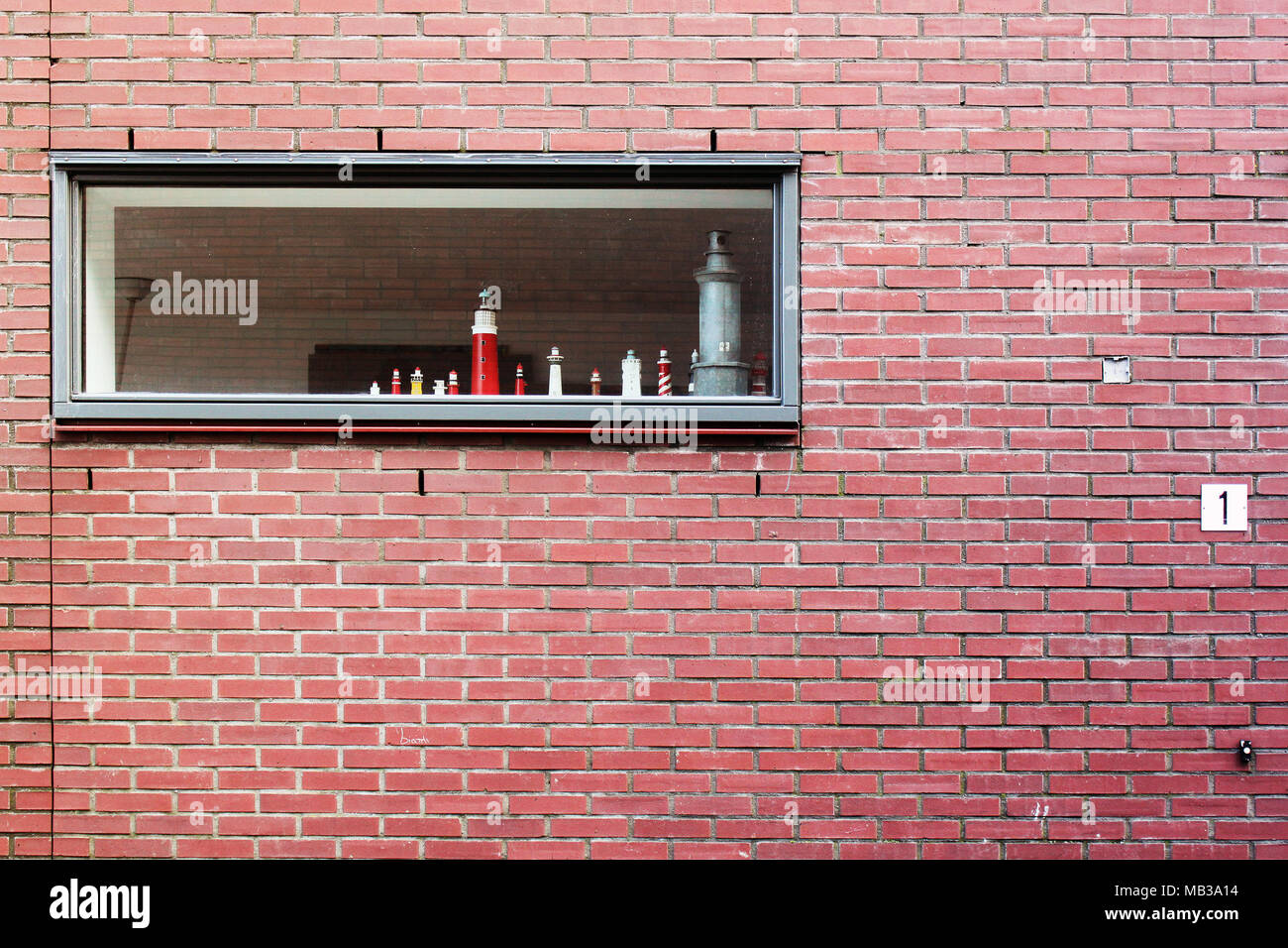 Physical models of lighthouses in the window and brick wall Stock Photo ...